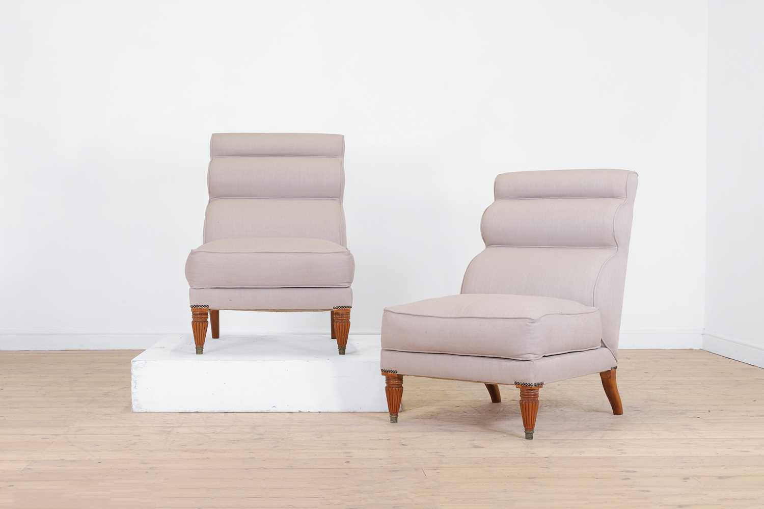 Lot 562 - A pair of linen-upholstered low chairs,
