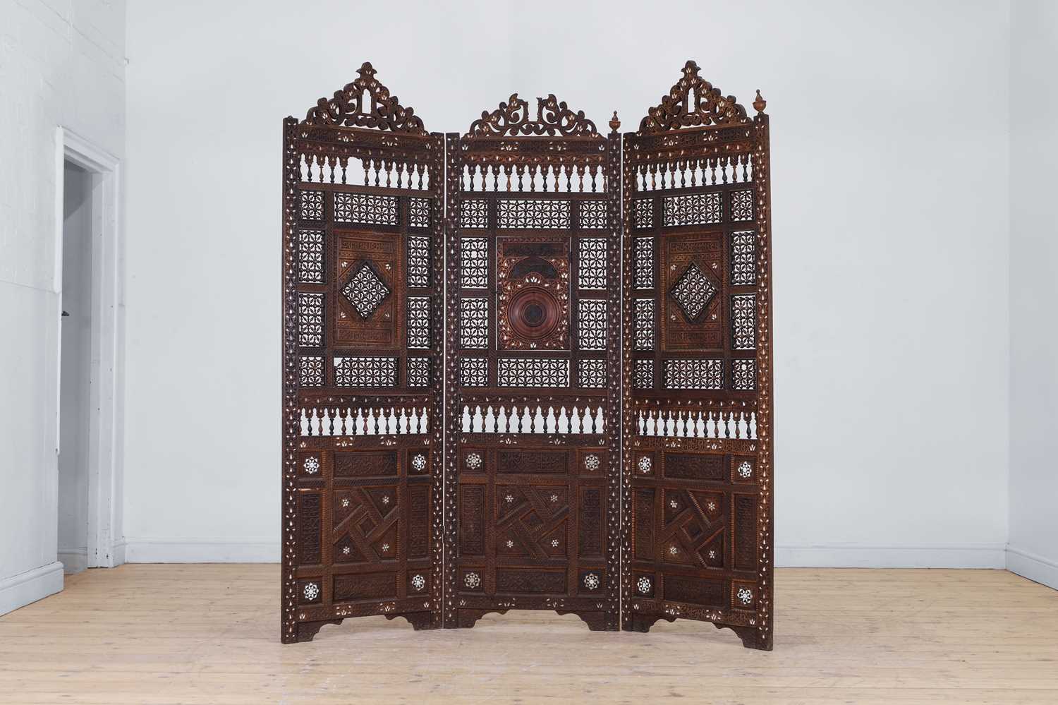 Lot 496 - A carved and inlaid wooden screen,