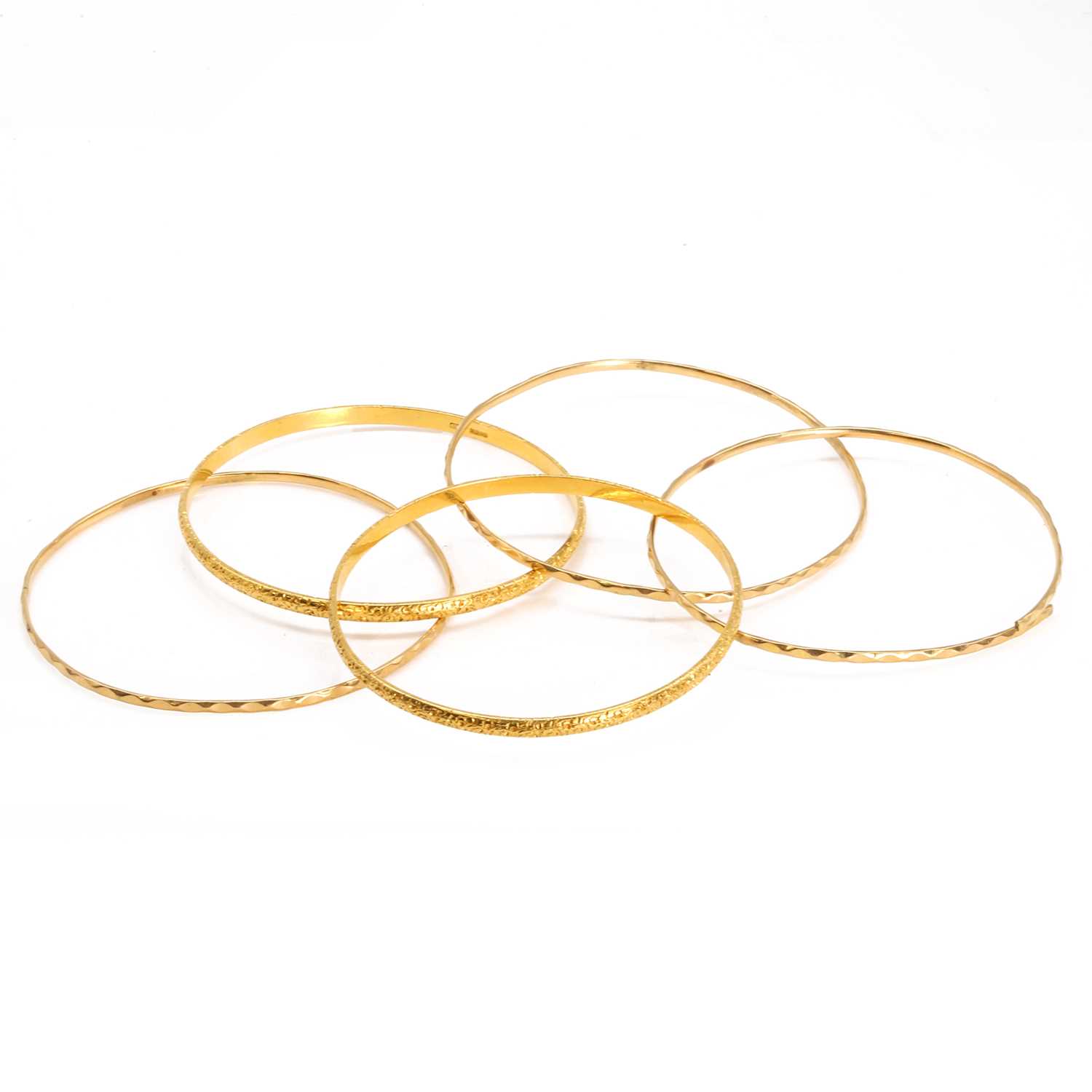 Lot 329 - A group of five gold bangles,