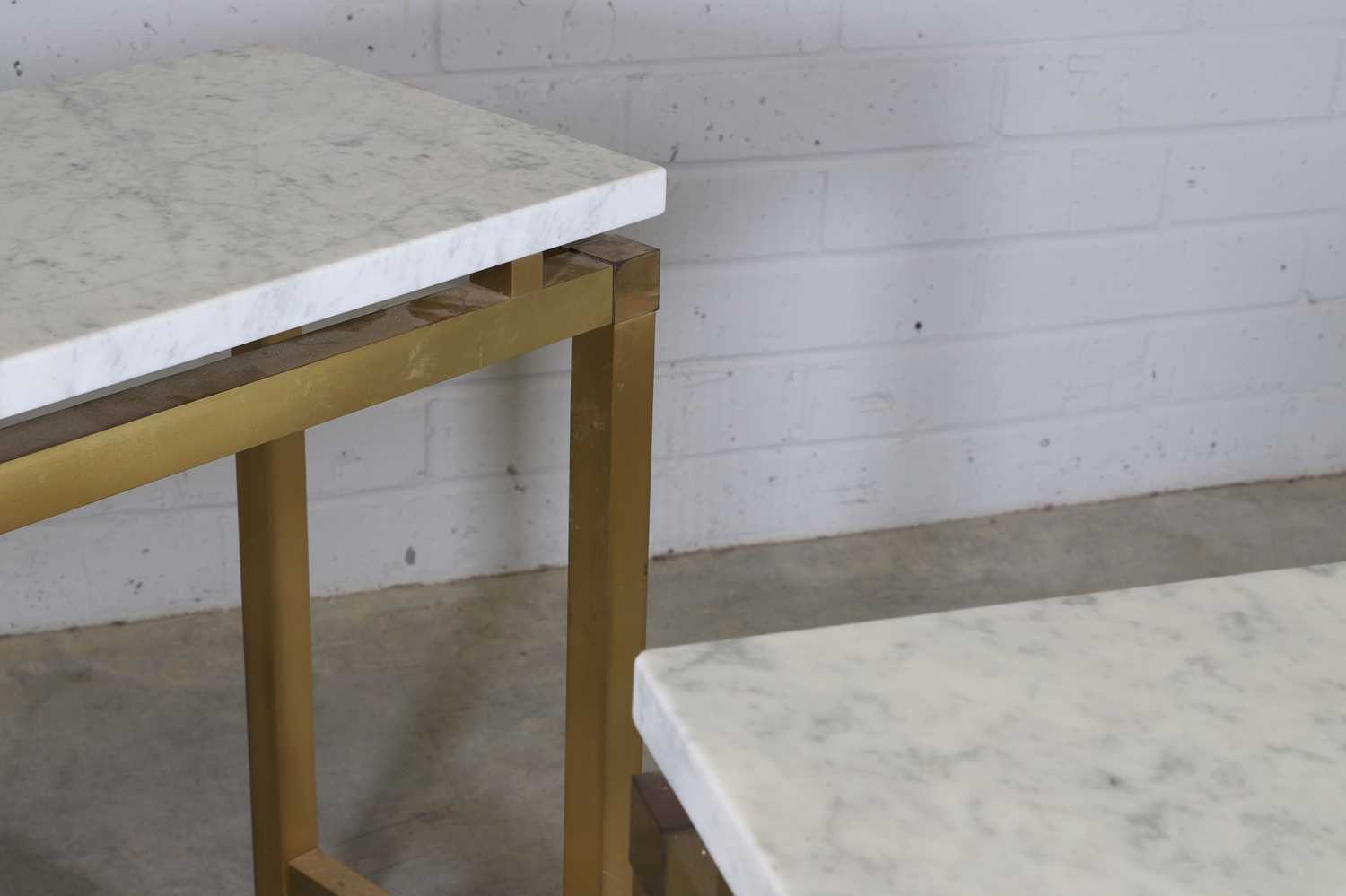 Lot 735 - A pair of brass and marble console tables,