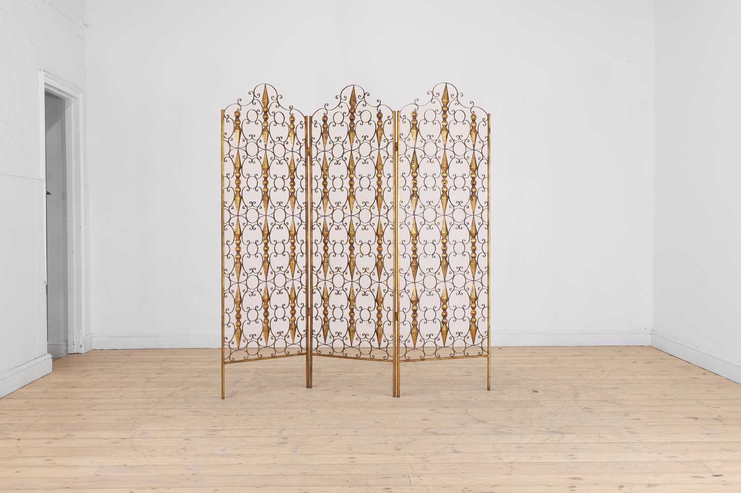 Lot 726 - A pierced gilt-metal folding screen,