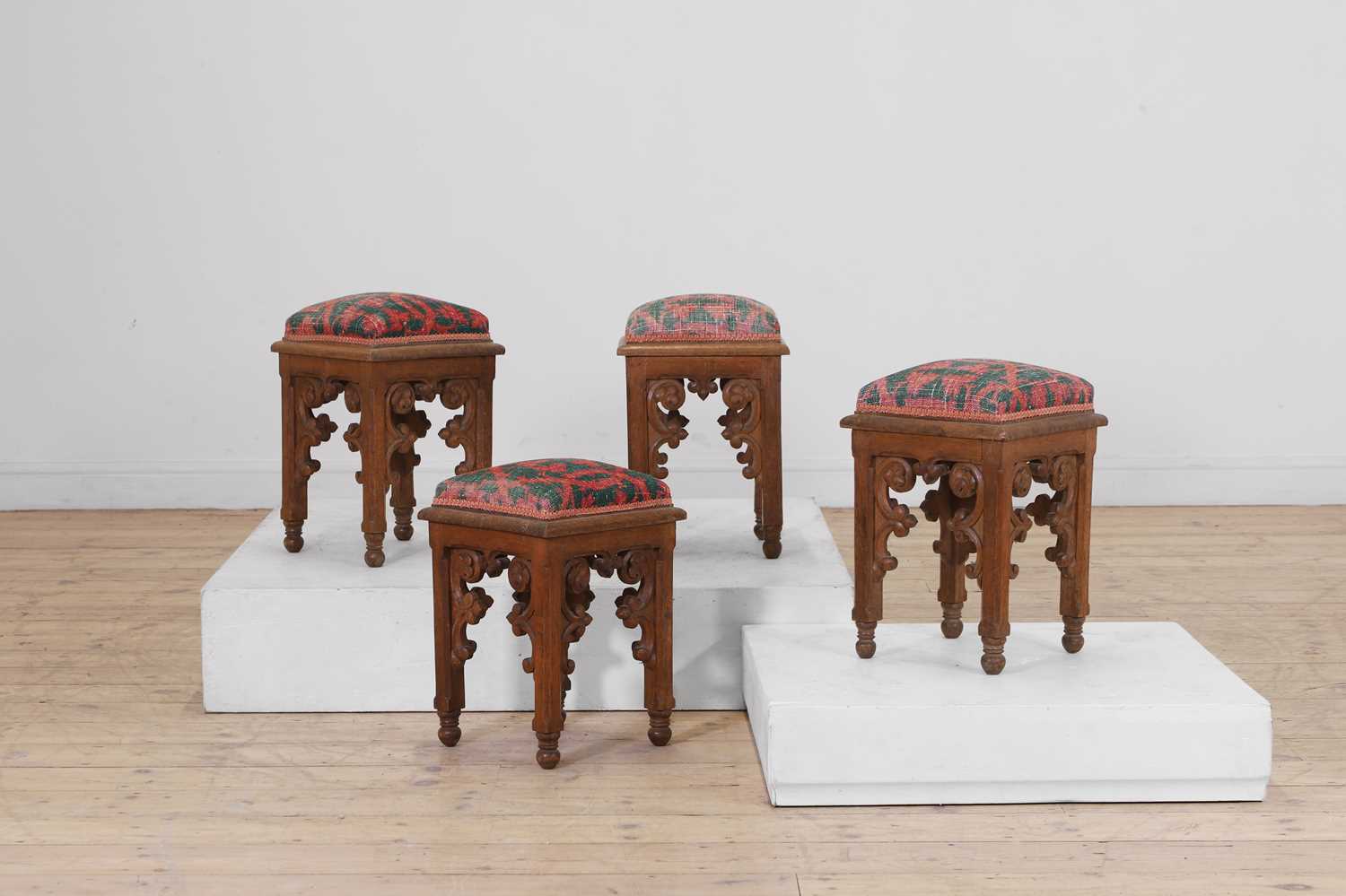 Lot 87 - A set of four Gothic Revival oak stools,