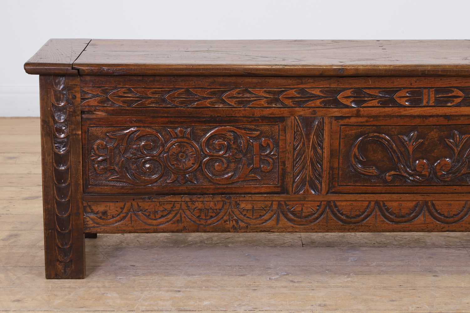 Lot 636 - A carved chestnut coffer,