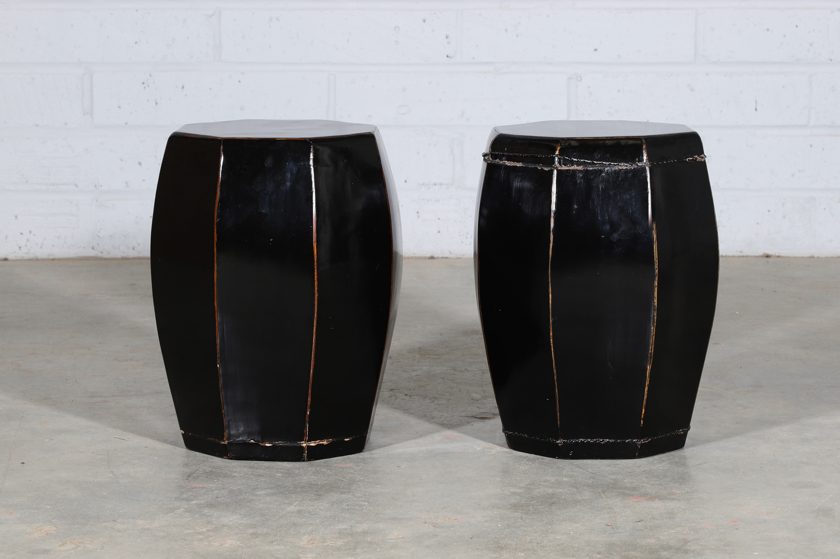 Lot 418 - A near pair of black-lacquered drum stools,