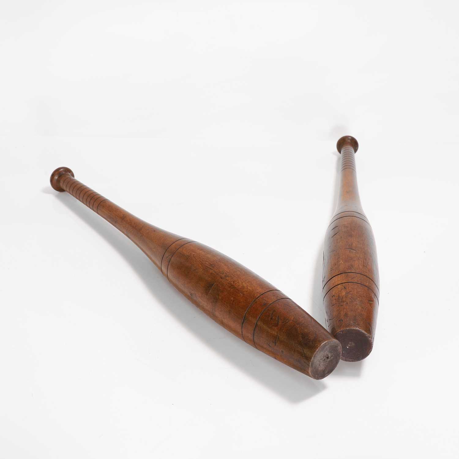 Lot 519 - A pair of hardwood exercise batons,