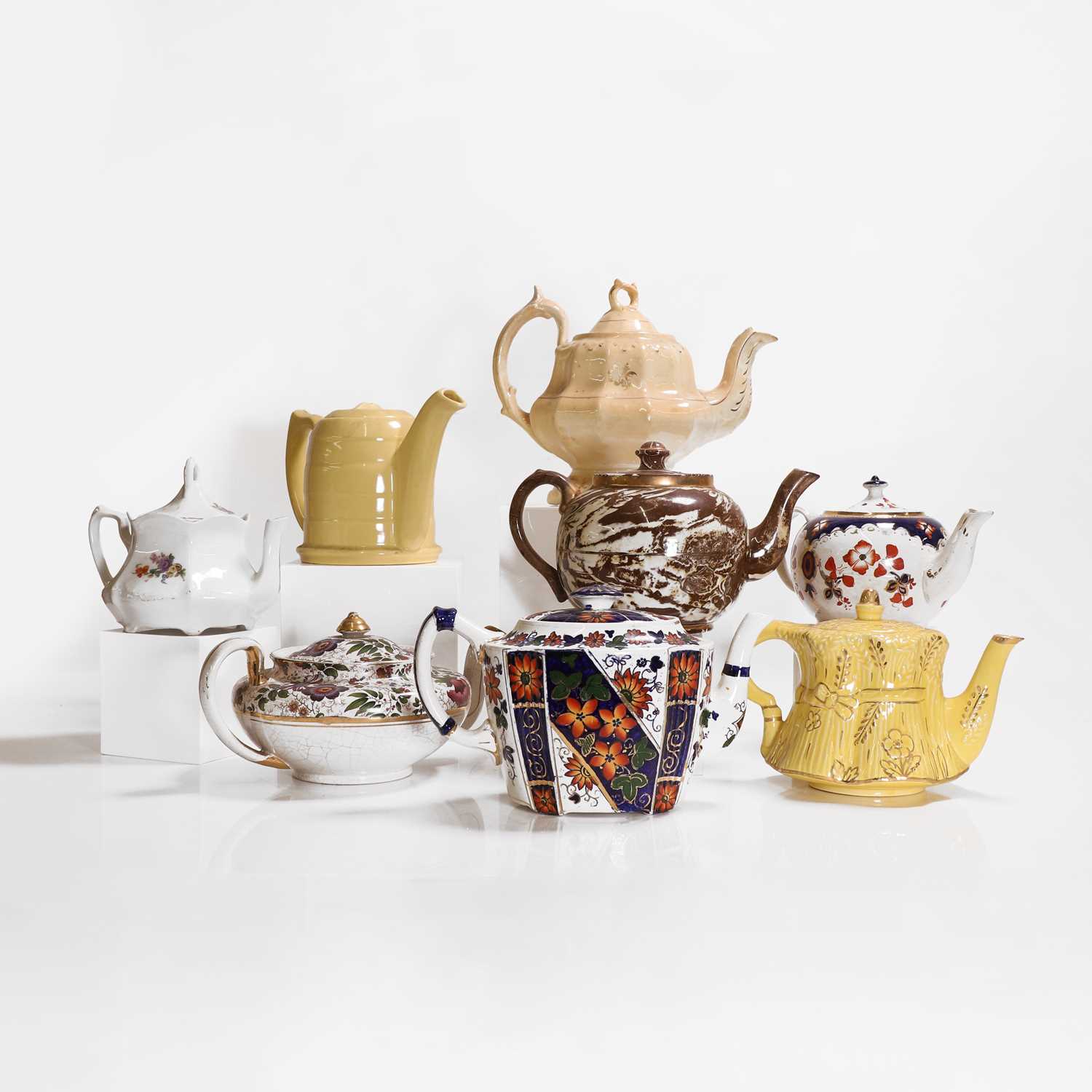 Lot 201 - Eight pottery teapots and covers,