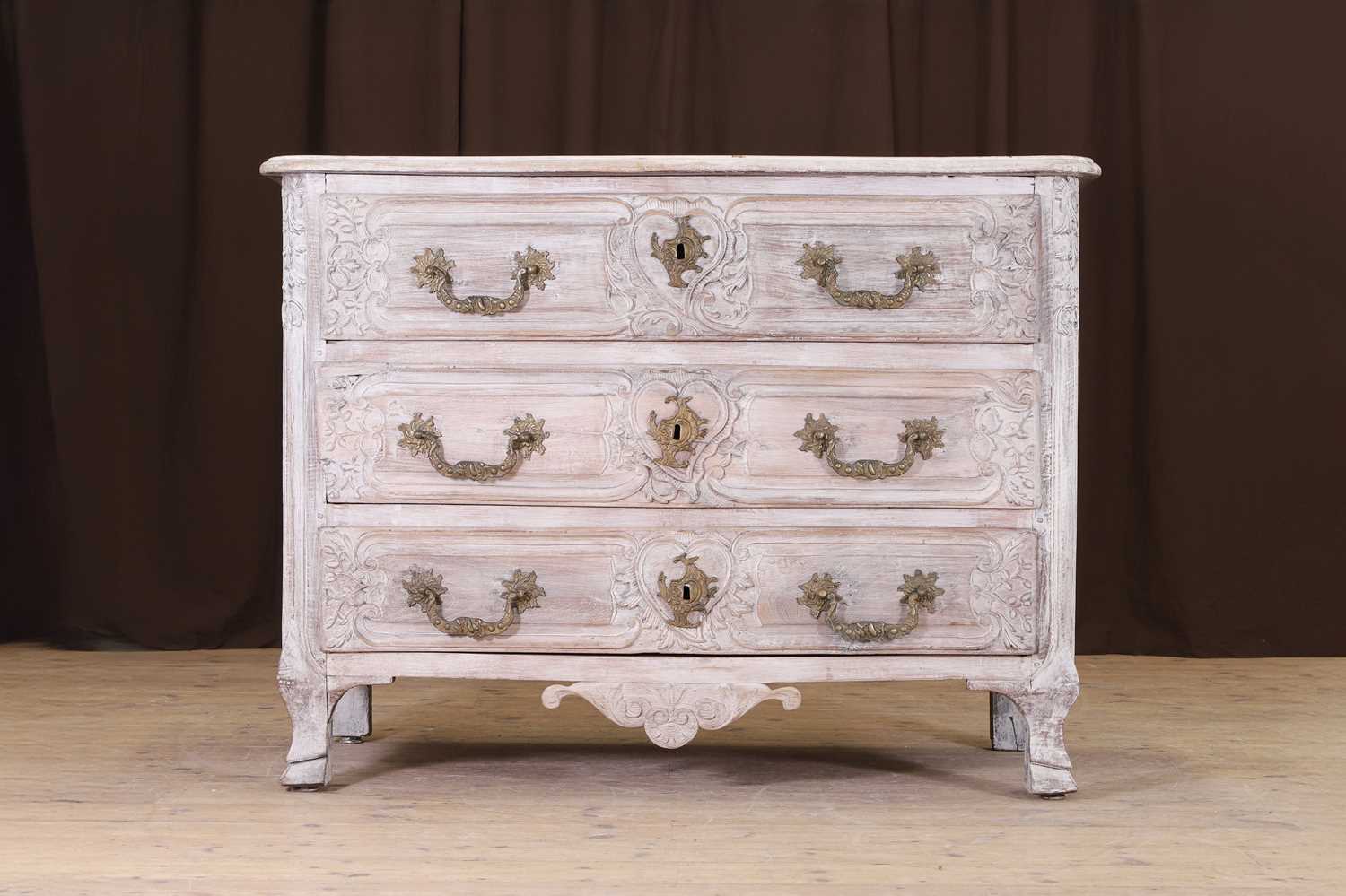 Lot 502 - A provincial Louis XV limed walnut commode,