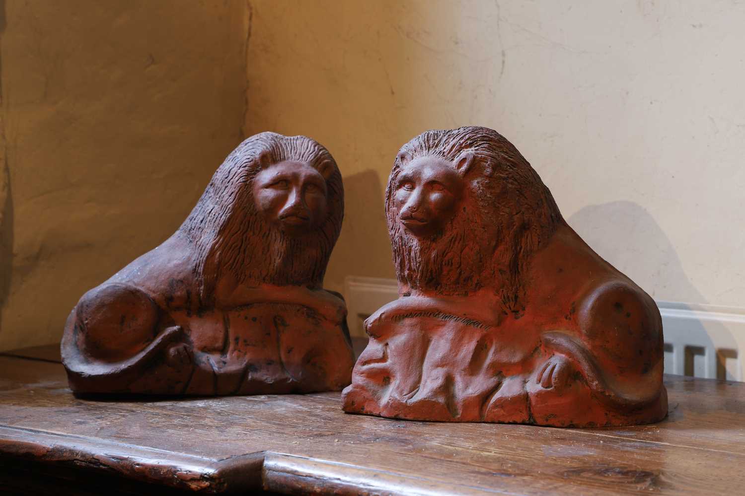 Lot 527 - A pair of large terracotta models of lions,