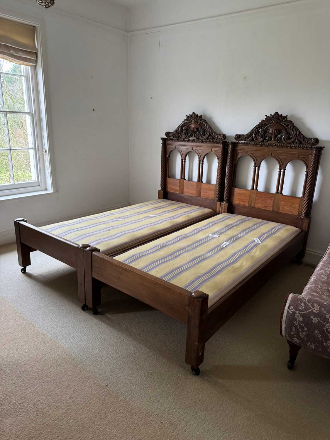 Lot 517 - A pair of carved walnut single beds,