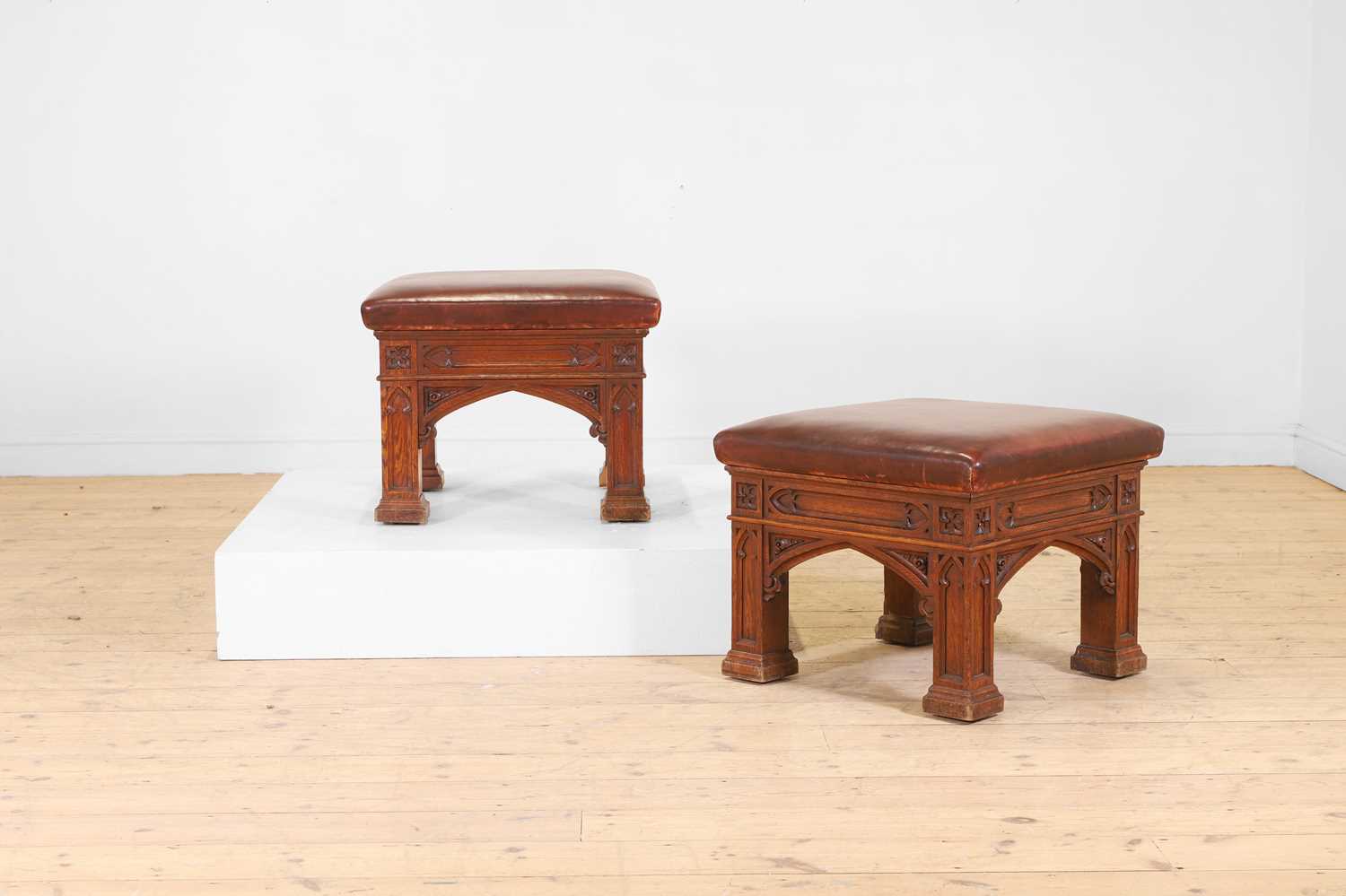 A pair of Gothic Revival oak stools after a design by