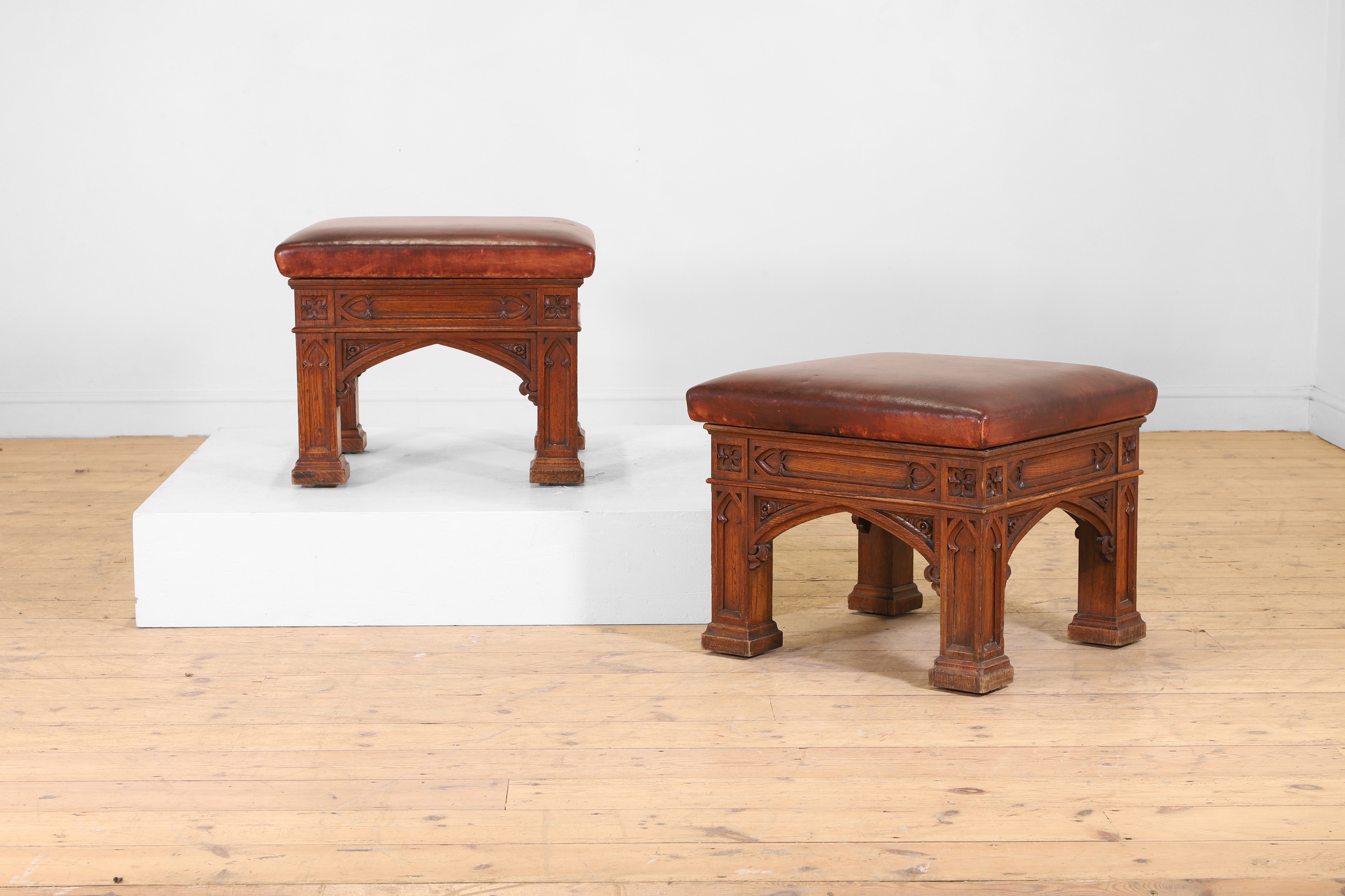 A pair of Gothic Revival oak stools after a design by