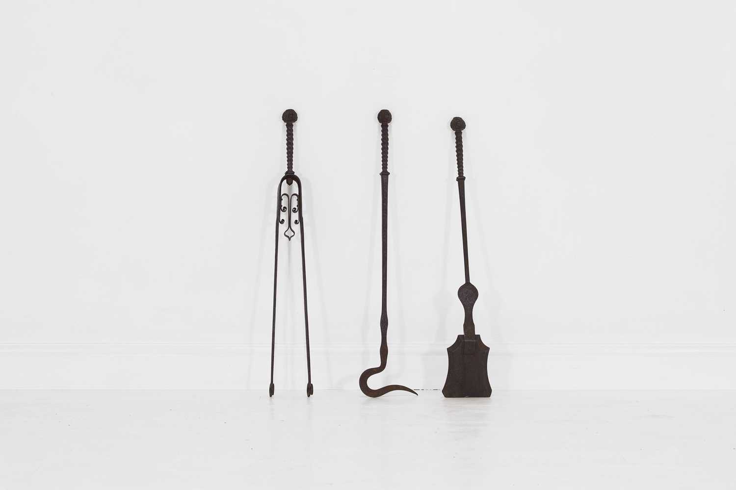 Lot 84 - A set of three wrought-steel fire tools,