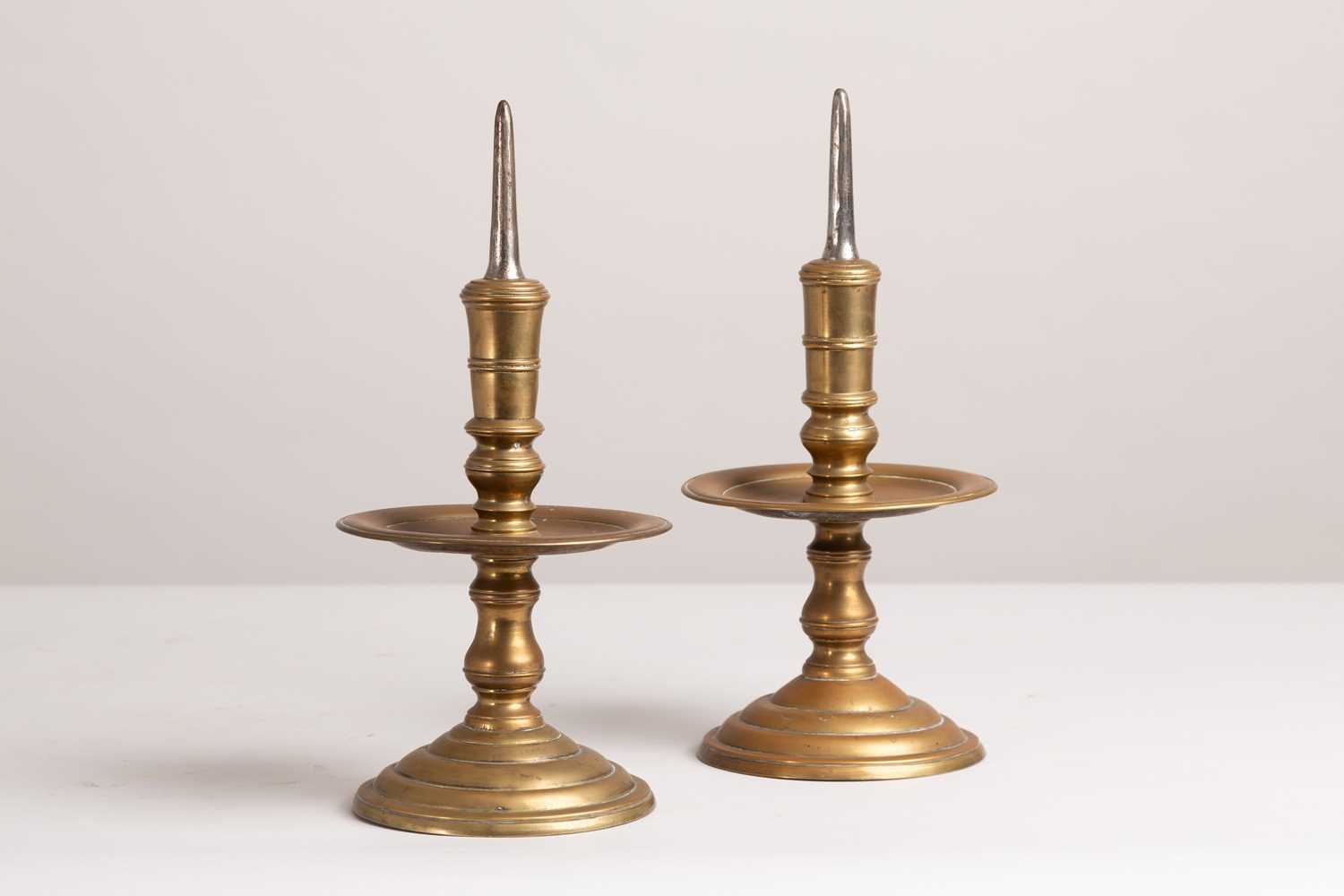 Lot 76 - A pair of brass or bell-metal candlesticks,