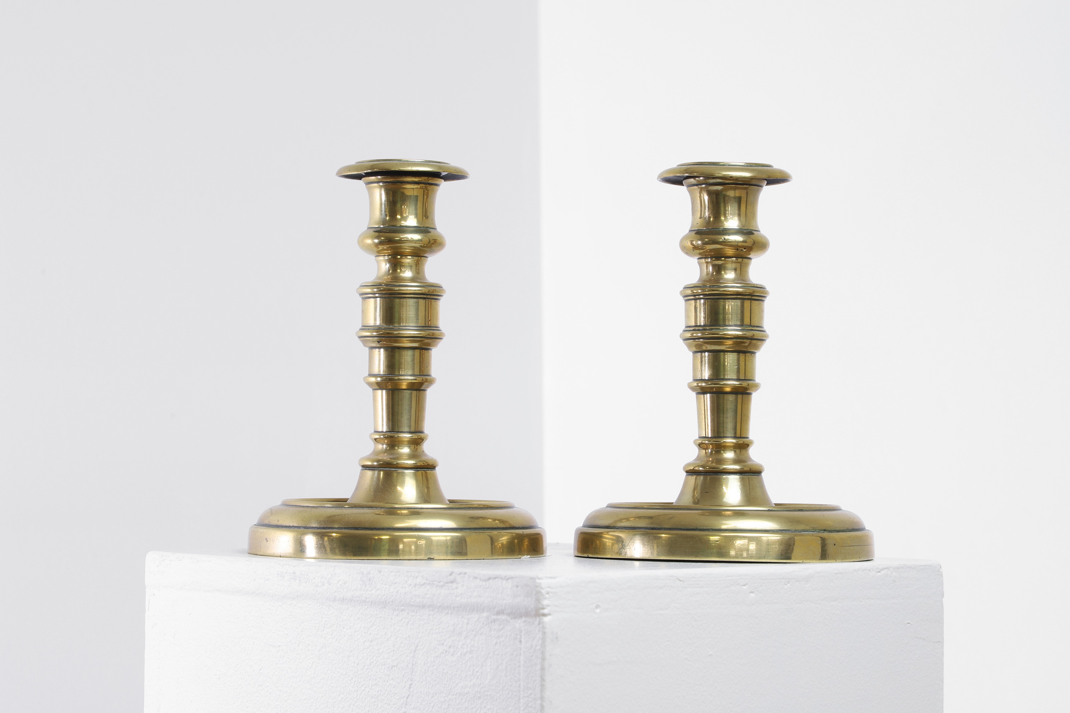 Lot 305 - A pair of George IV brass candlesticks,