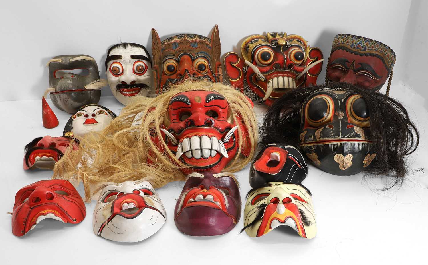 Lot 144 - A collection of Indonesian wooden masks,