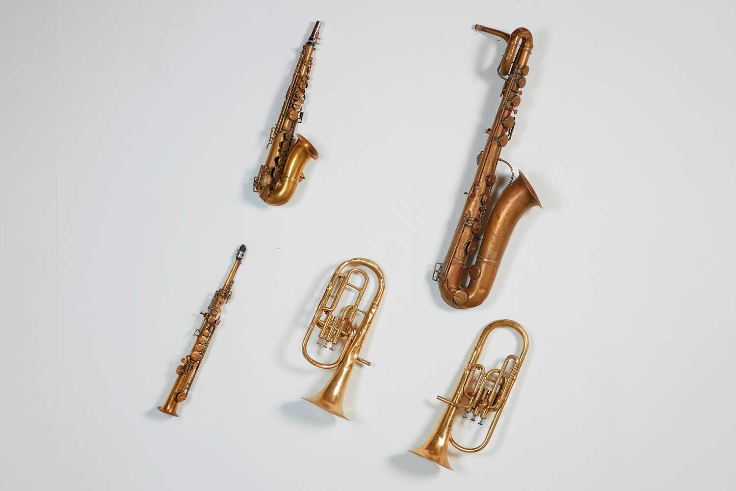 Lot 46 - Five brass and silvered musical instruments,