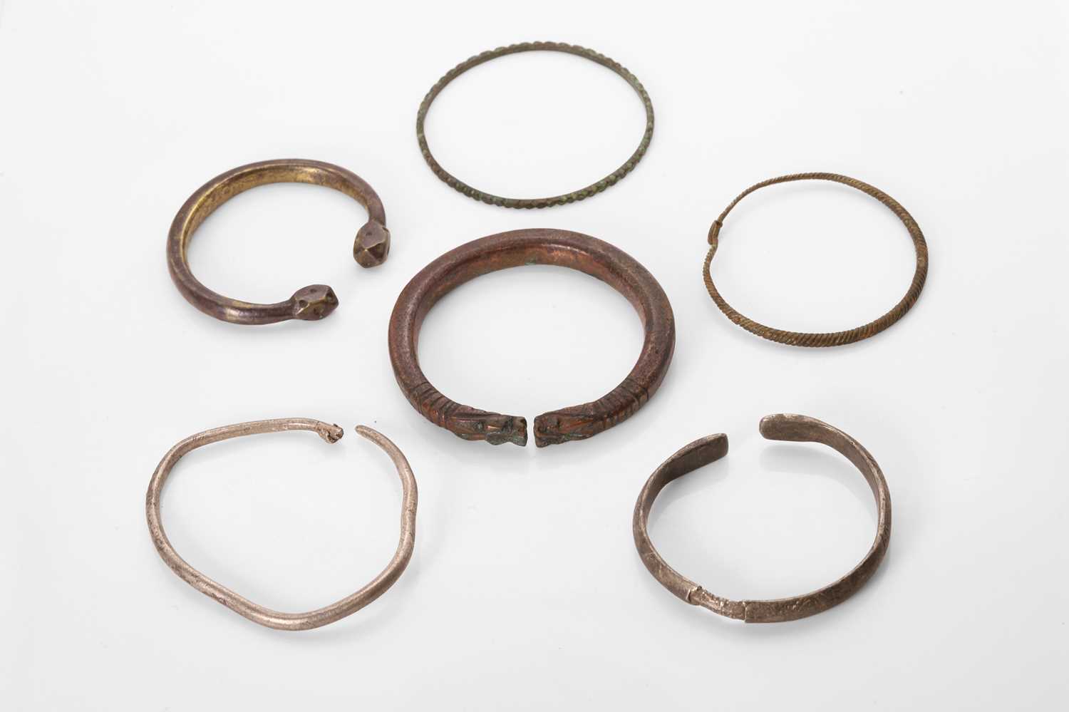Lot 188 - A group of ancient and later metal bangles,