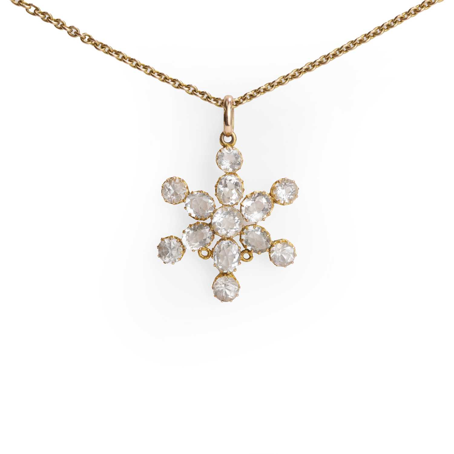Lot 1019 - A rock crystal snowflake pendant on chain,