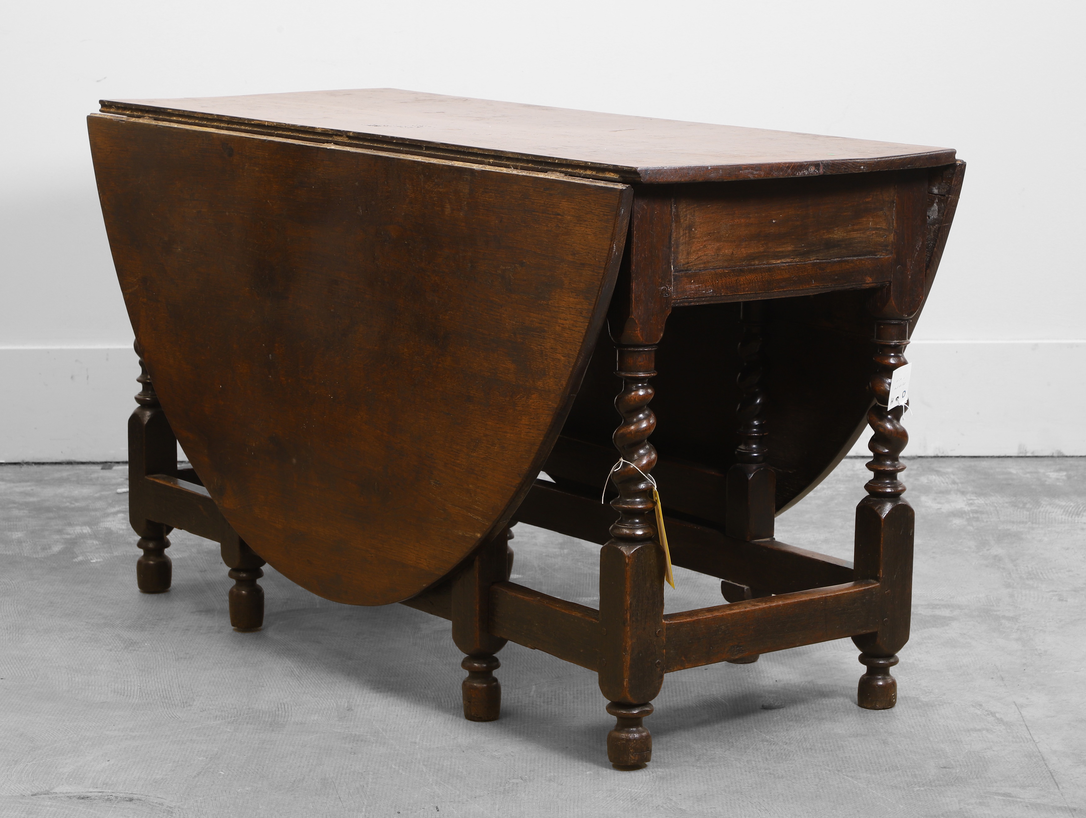 Lot 532 - An oak gateleg dining table,